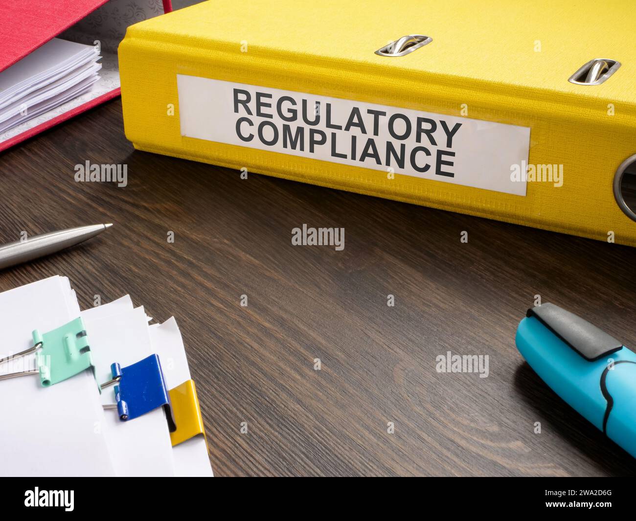 Folder with regulatory compliance and papers Stock Photo - Alamy