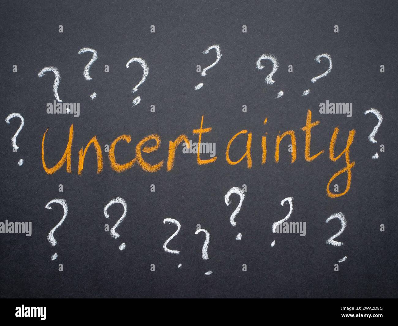 Chalk handwritten question marks and word uncertainty Stock Photo - Alamy