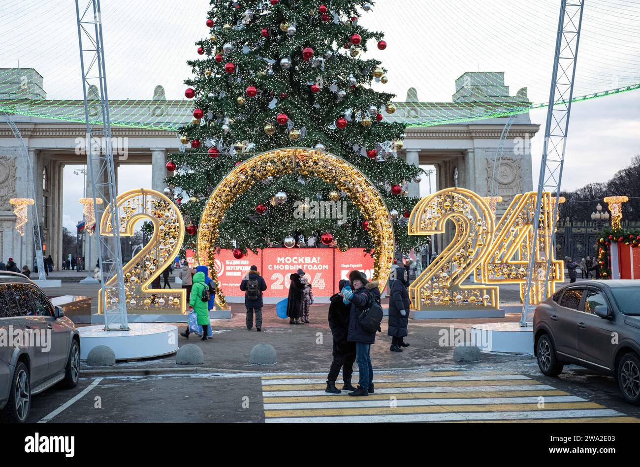 Moscow, Russia. 1st Jan, 2024. People take photos in front of a light ...