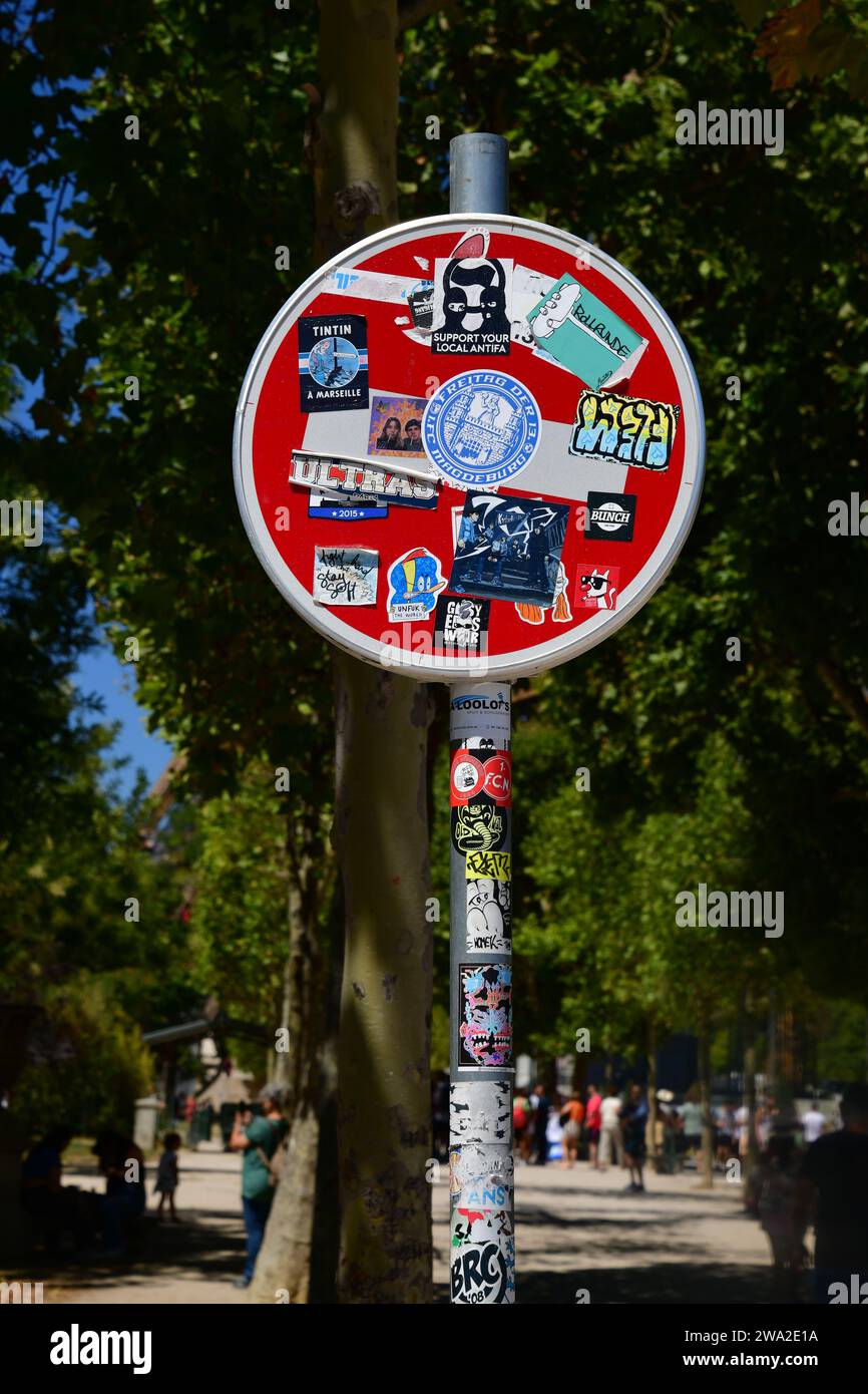Many stickers on a Parisian no-entry sign in the park at the base of ...