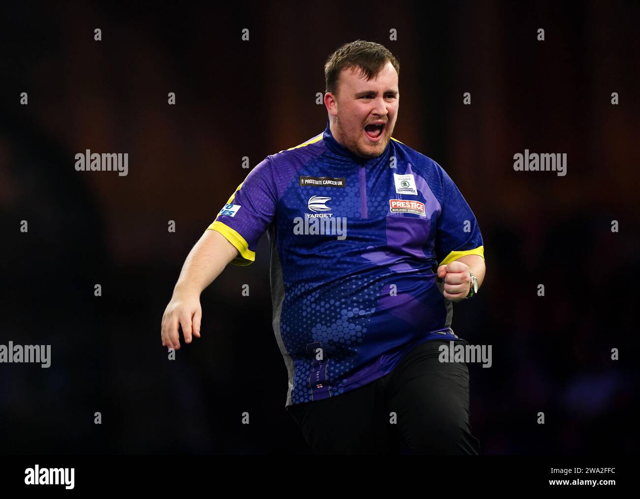 Luke Littler reacts during his match against Brendan Dolan (right) on ...