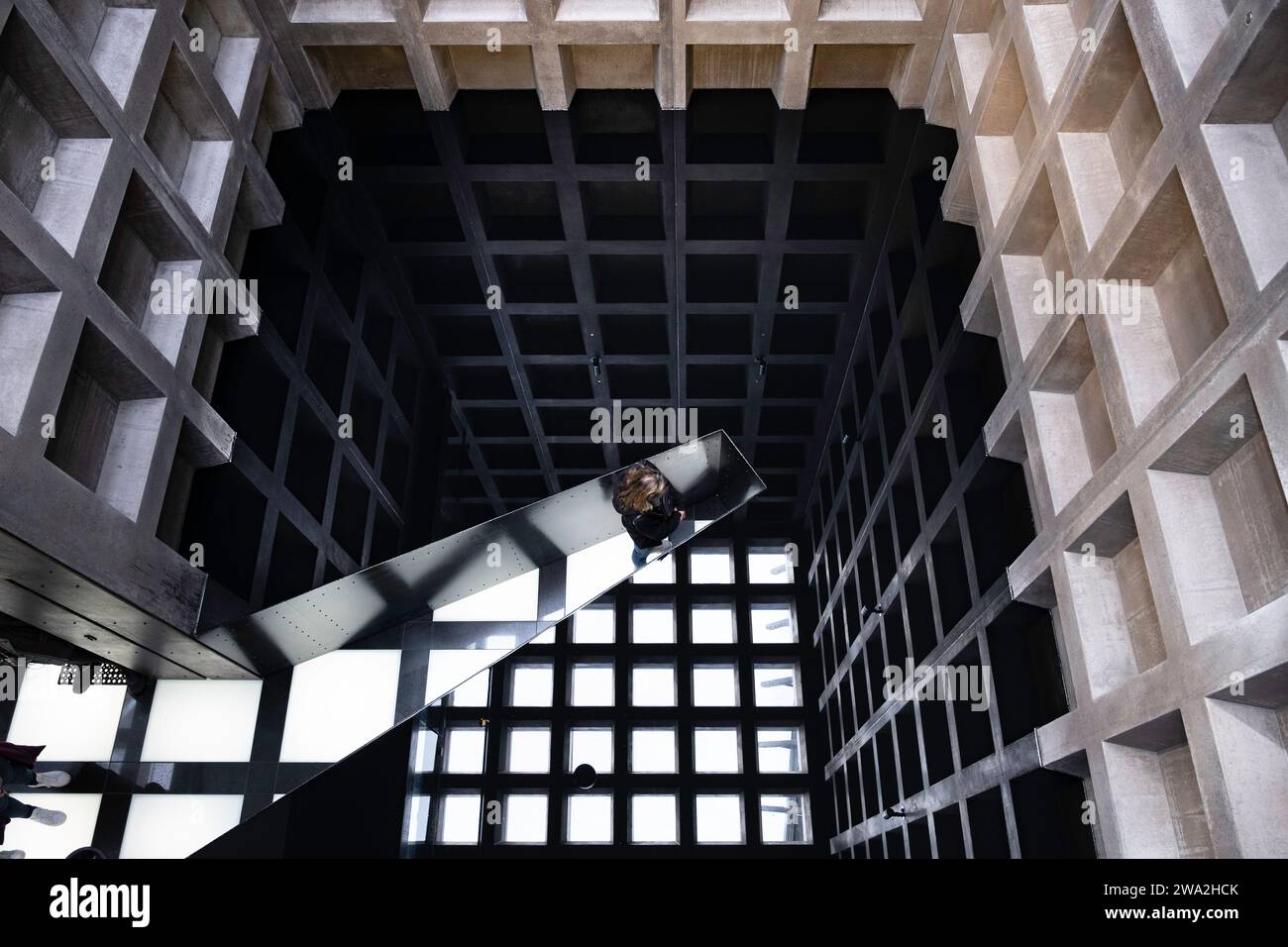 Woman walks gingerly in an art installation over oil at the MONA Museum ...