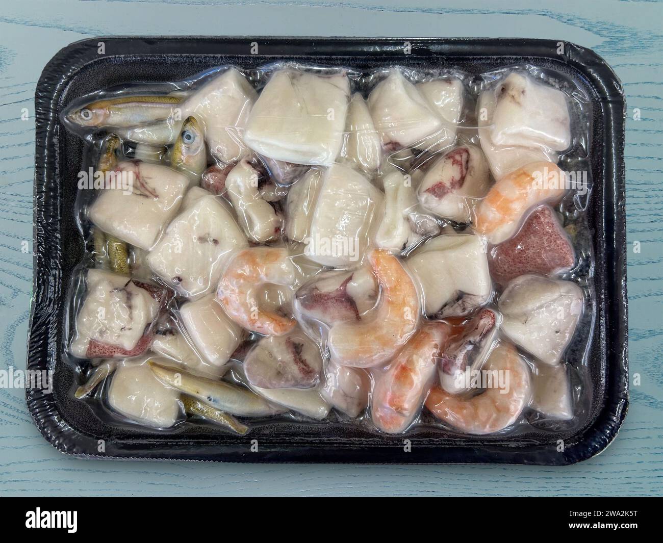 Mixed cleaned and cut fish ready for cooking in pieces frozen in vacuum ...