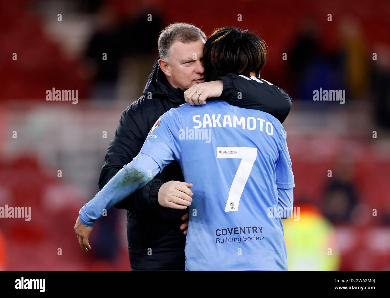 Coventry City manager Mark Robins greets Coventry City's Tatsuhiro ...