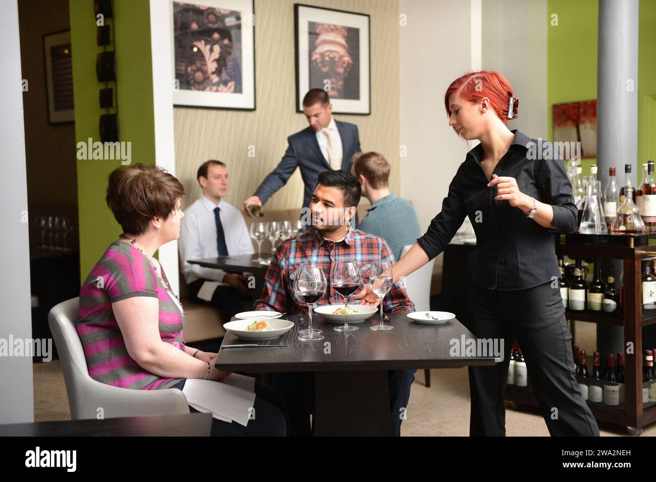 A waitress serves customers in a restaurant, UK Stock Photo - Alamy A waitress serves customers in a restaurant, UK Stock Photo - Alamy