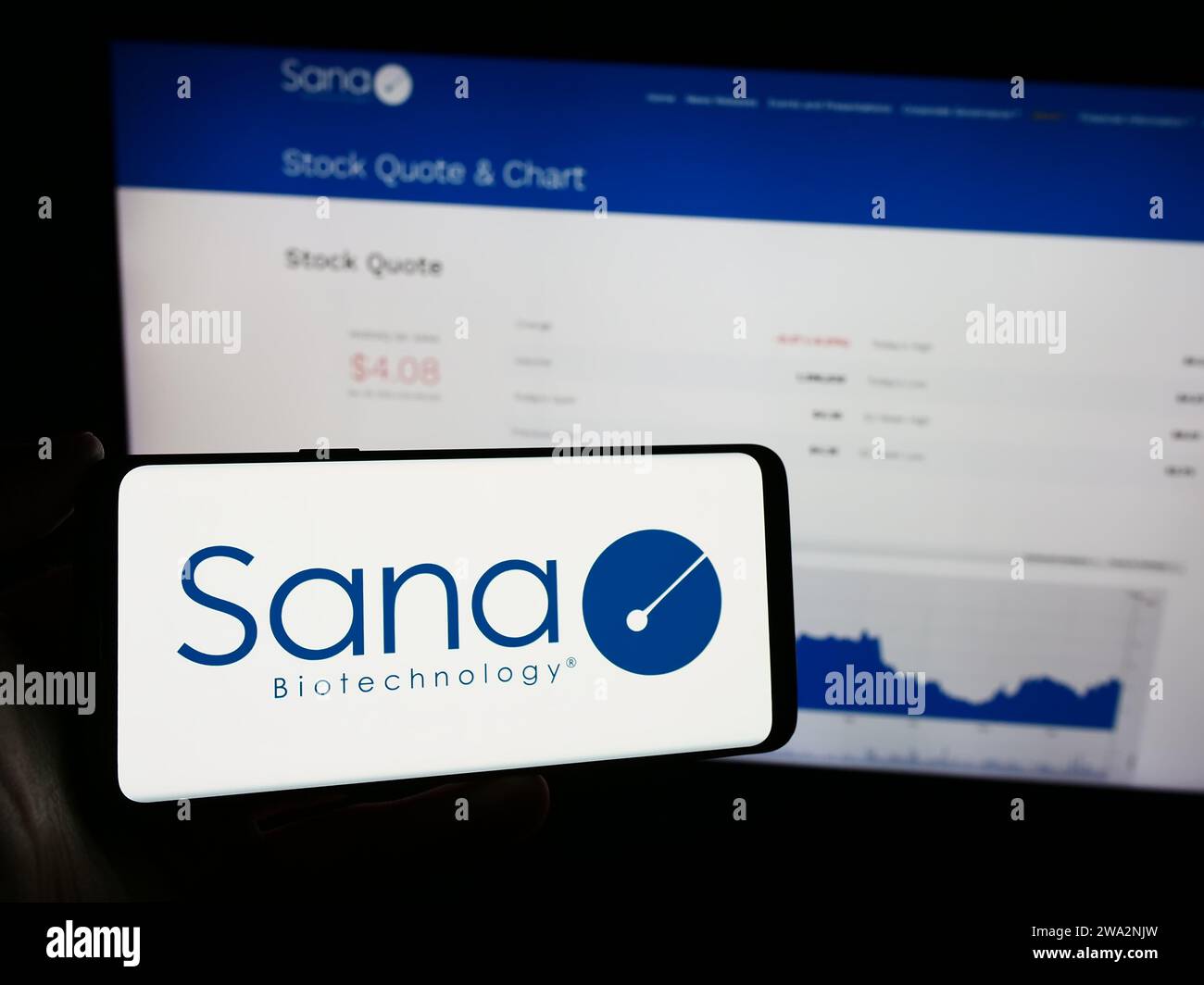 Person holding mobile phone with logo of American biotech research ...