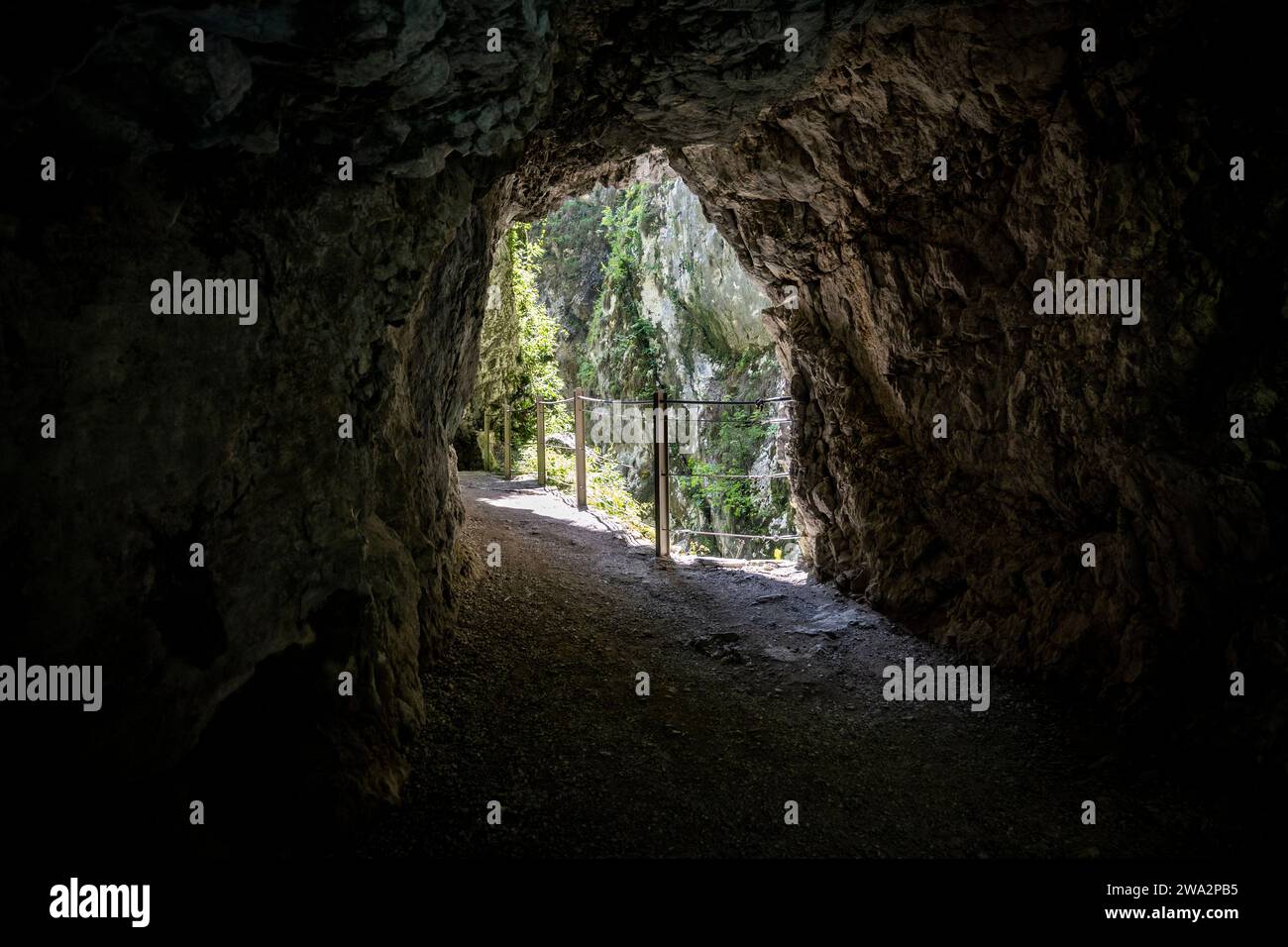 Beautiful tunnel leading through the steep, rocky cliffs of Soca river ...