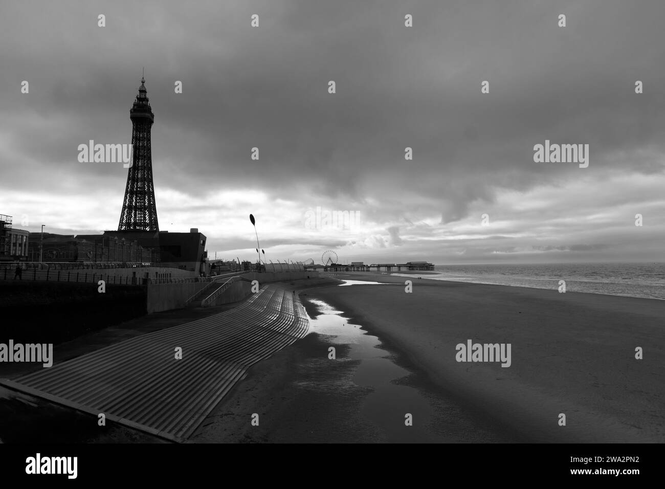 A moody Black and white photo along Blackpool beach with the pier and ...