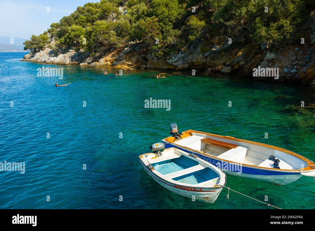 Two small fishing boats float on the clear waters on the Fethiye ...