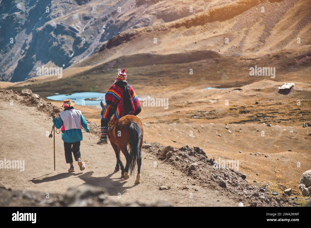 Peruvian Andean man wearing traditional colorful clothing walking up ...
