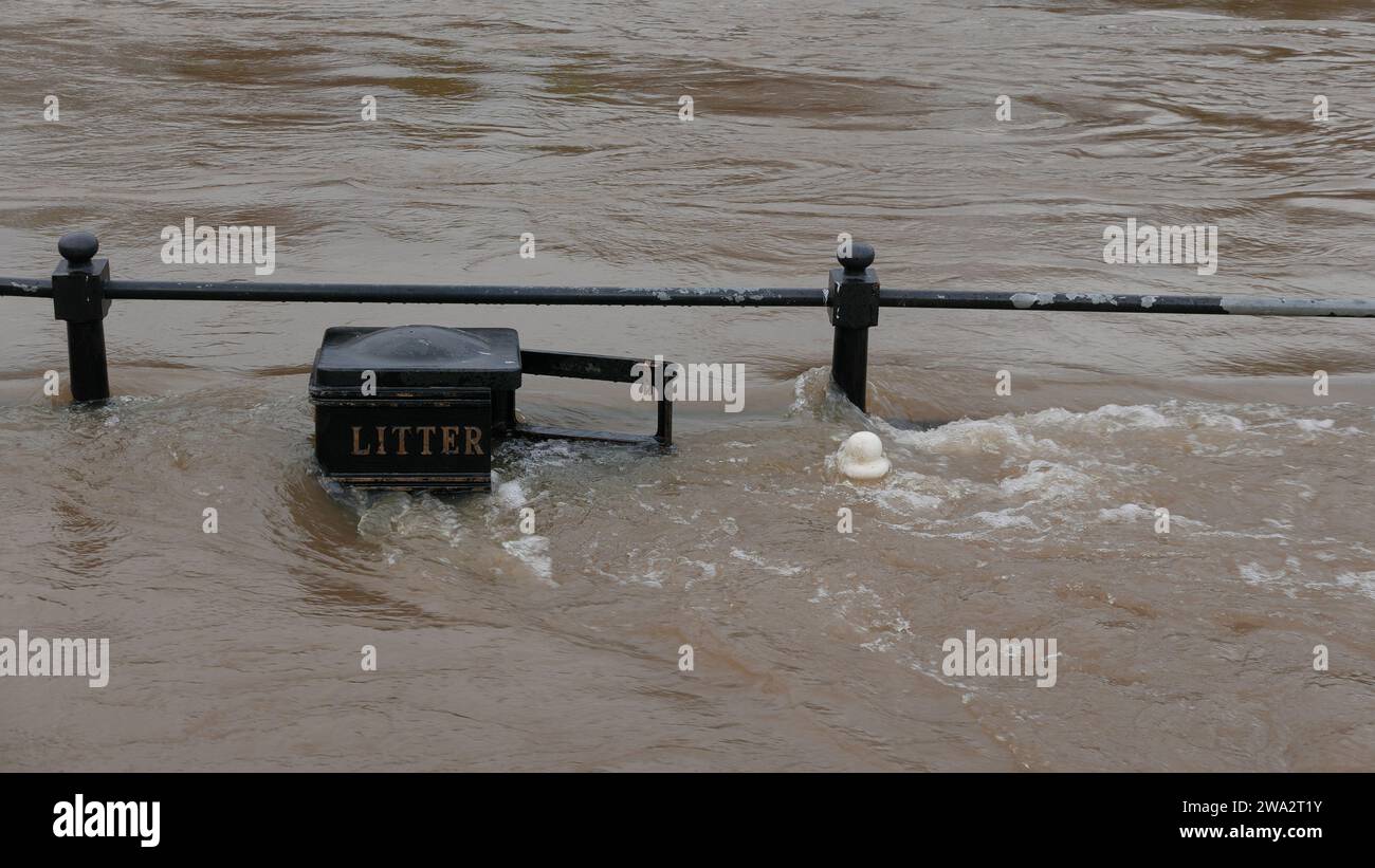 The River Severn flooding its banks covering railings and a litter bin ...