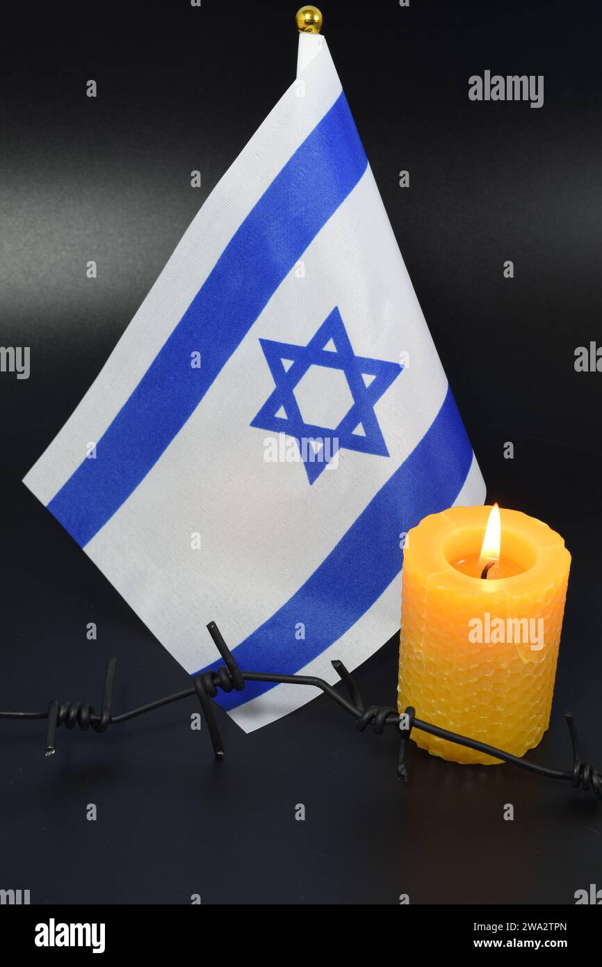 Wax candle and Israel flag on blue background Stock Photo - Alamy