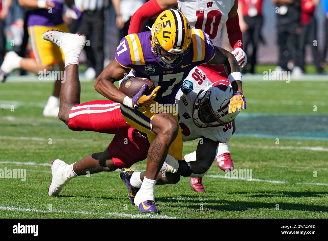 LSU wide receiver Chris Hilton Jr. (17) is taken down by Wisconsin ...