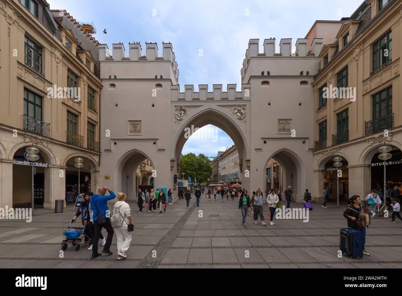Residents and tourists walk through the Karlstor Gate on the popular ...