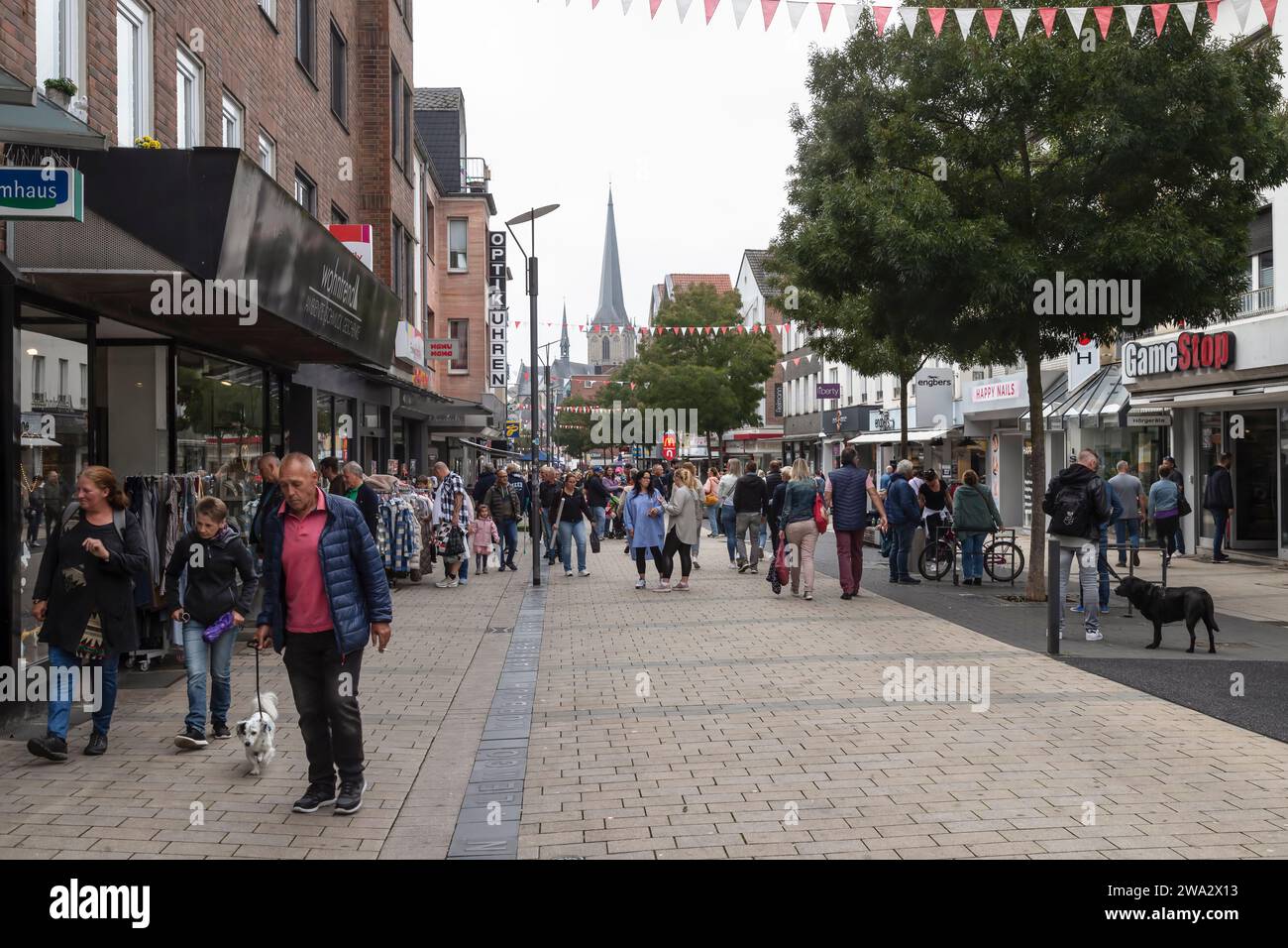 People stroll in the pleasant shopping street in the center of the ...