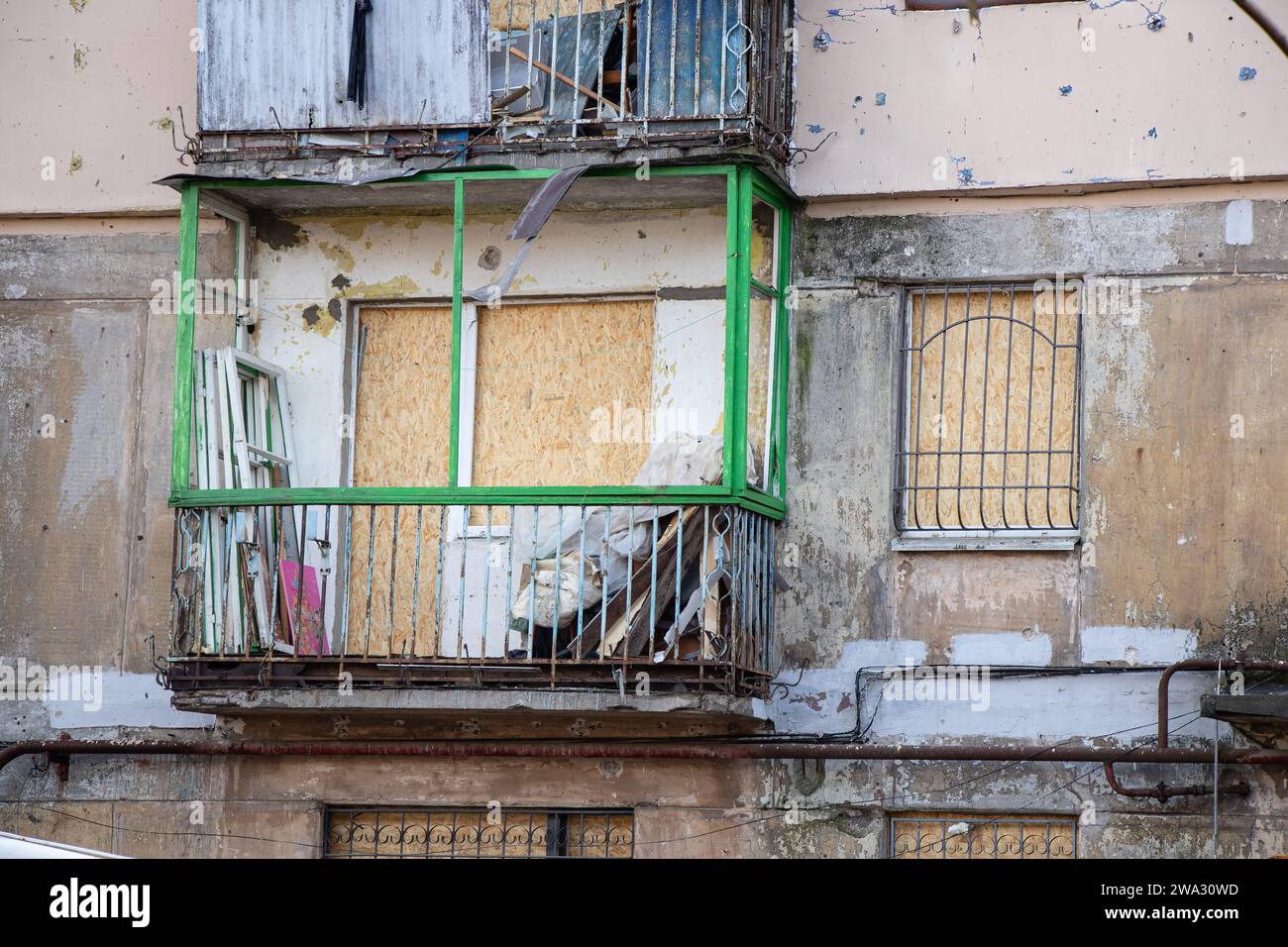 Residential building after a blast wave with broken windows covered ...