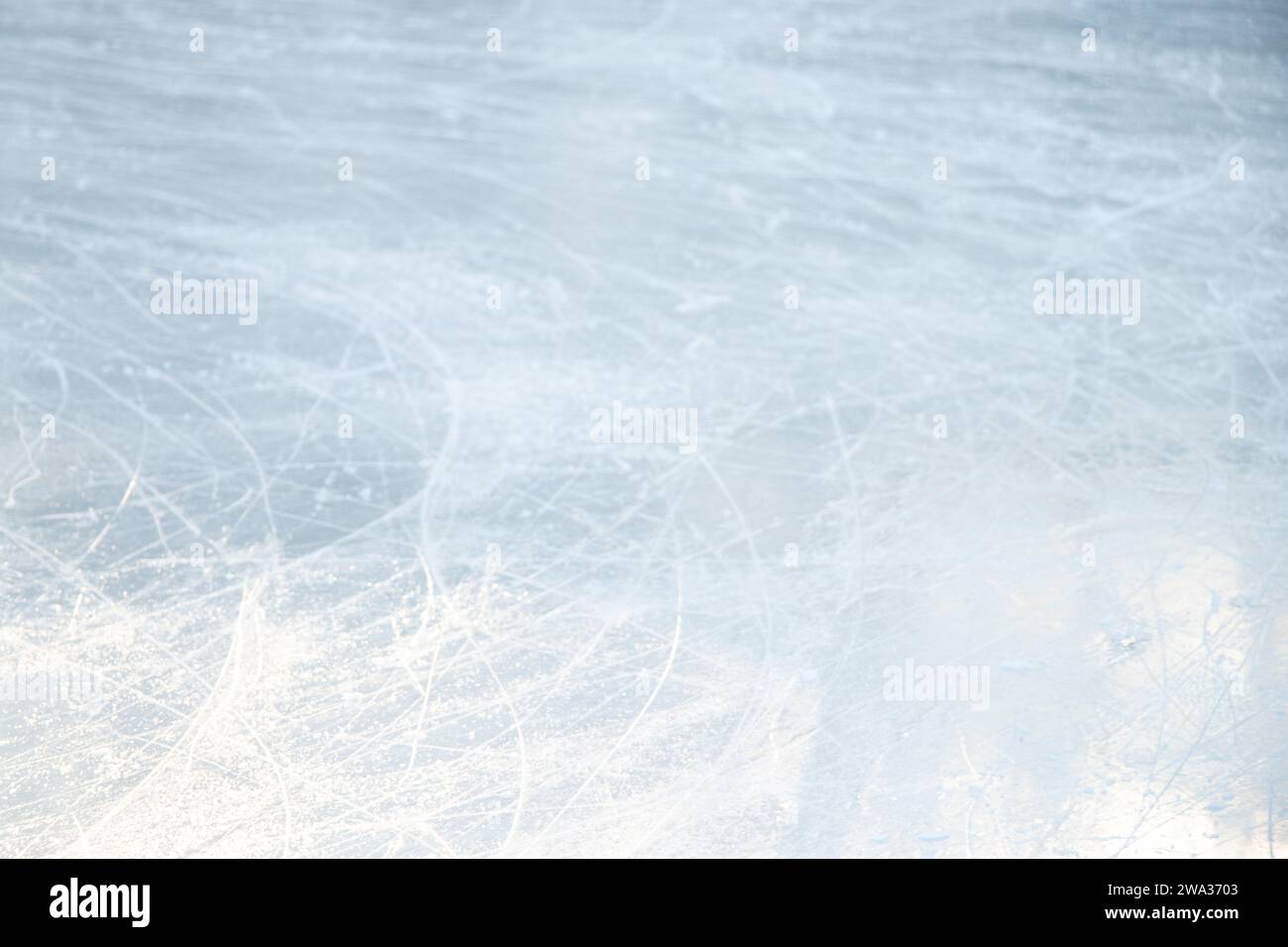 Ice on an outdoor skating rink on the street in a park in the sun in ...