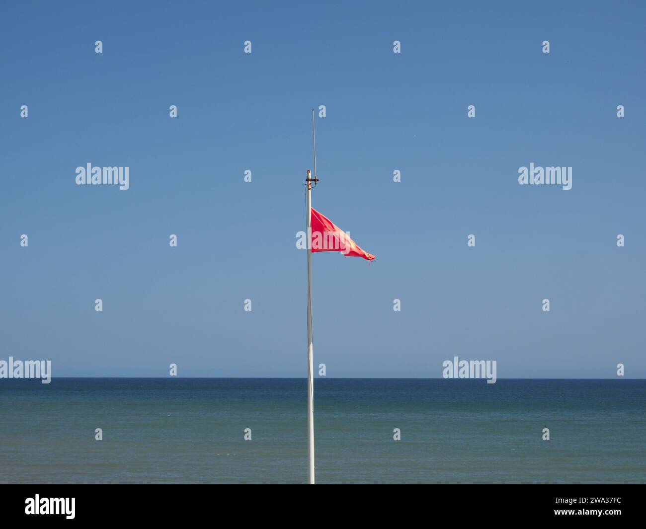 Red Flag Meaning High Hazard At The Sea Stock Photo - Alamy