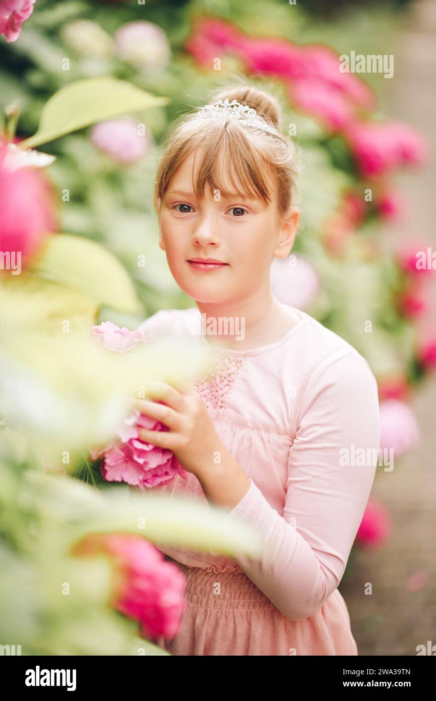 Portrait of adorable ballerina girl playing in hydrangea garden ...