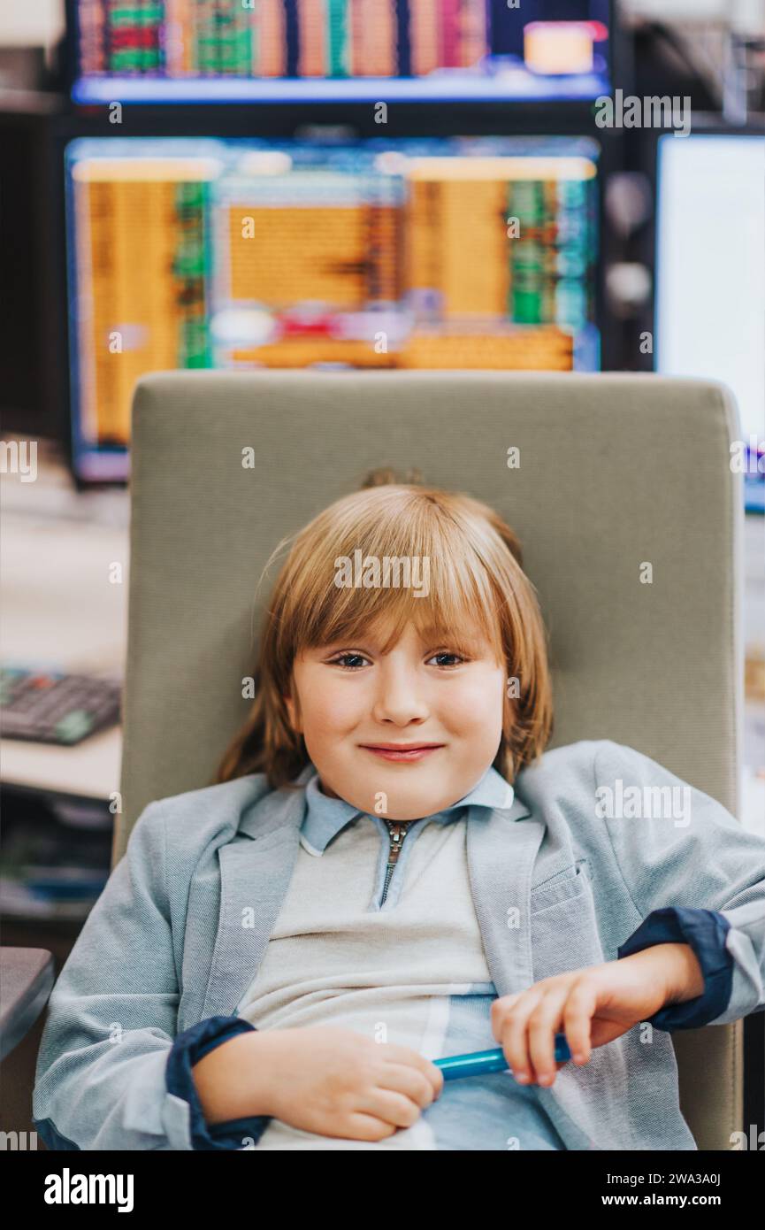 Adorable little boy visiting parents working place, educational program ...