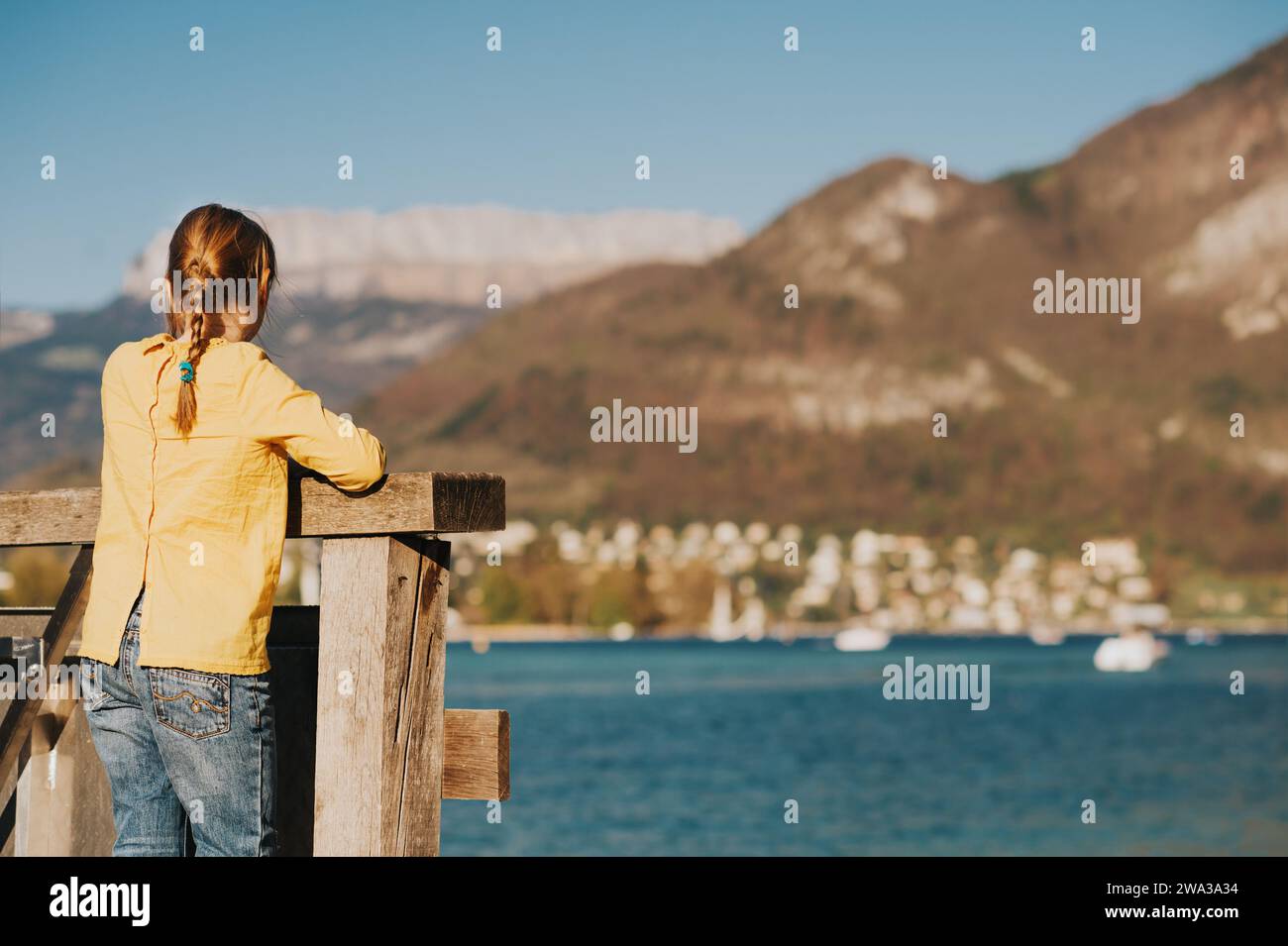 Little kid girl admaring Annecy lake in erly spring, family travel with ...