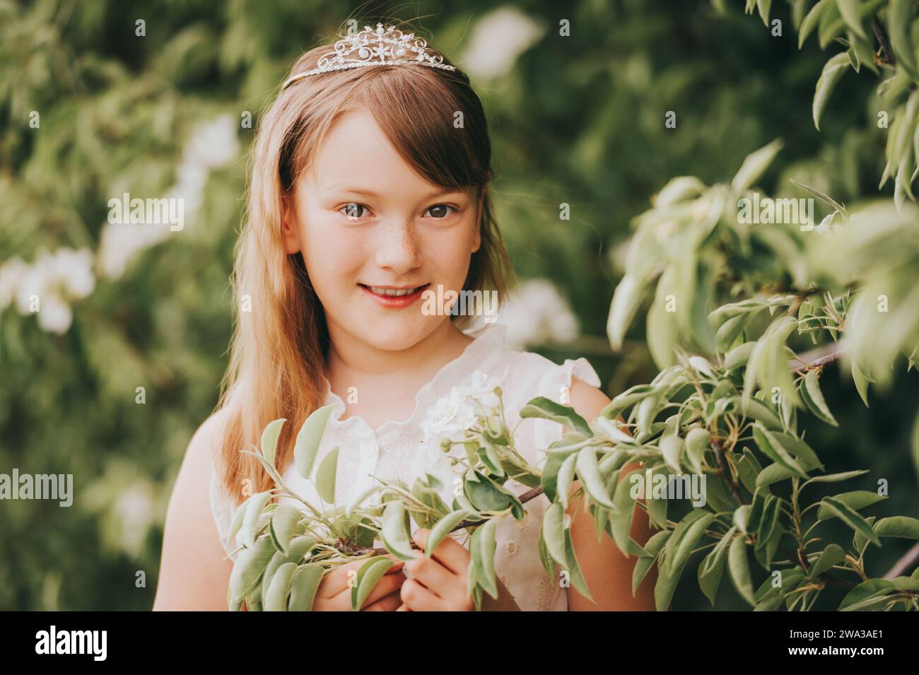 Spring close up portrait of adorable kid girl wearing a crown Stock ...