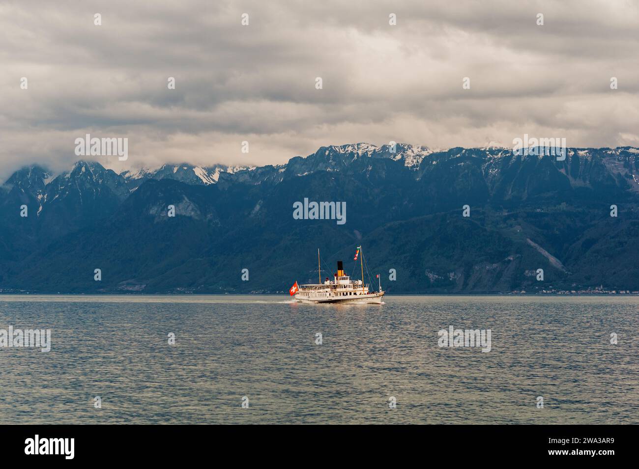 Steam boat with swiss and french flags floating on Lake Geneva or Lac ...