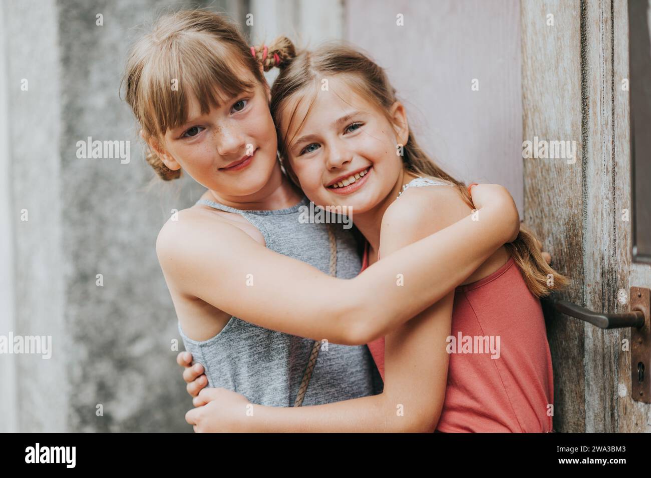 Summer portrait of two adorable kid girls hugging each other Stock ...