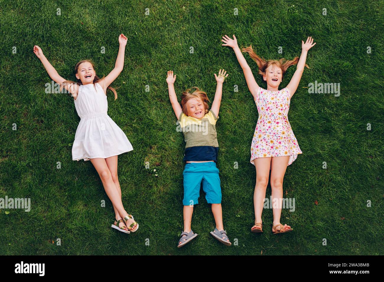Happy children having fun outdoors. Kids playing in summer park. Little ...