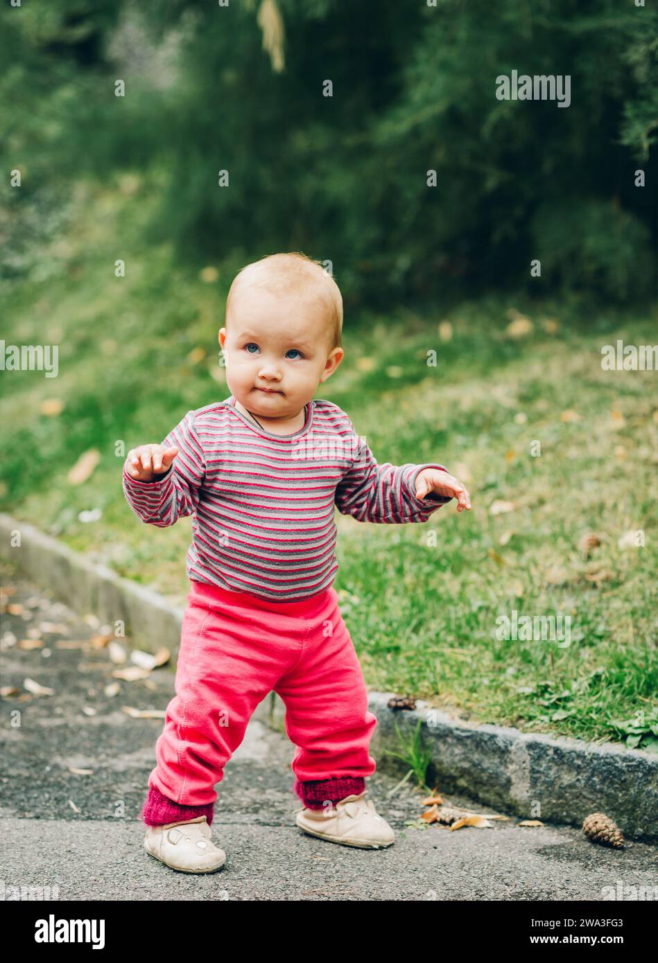 Adorable baby girl of 9-12 months old playing outside Stock Photo - Alamy