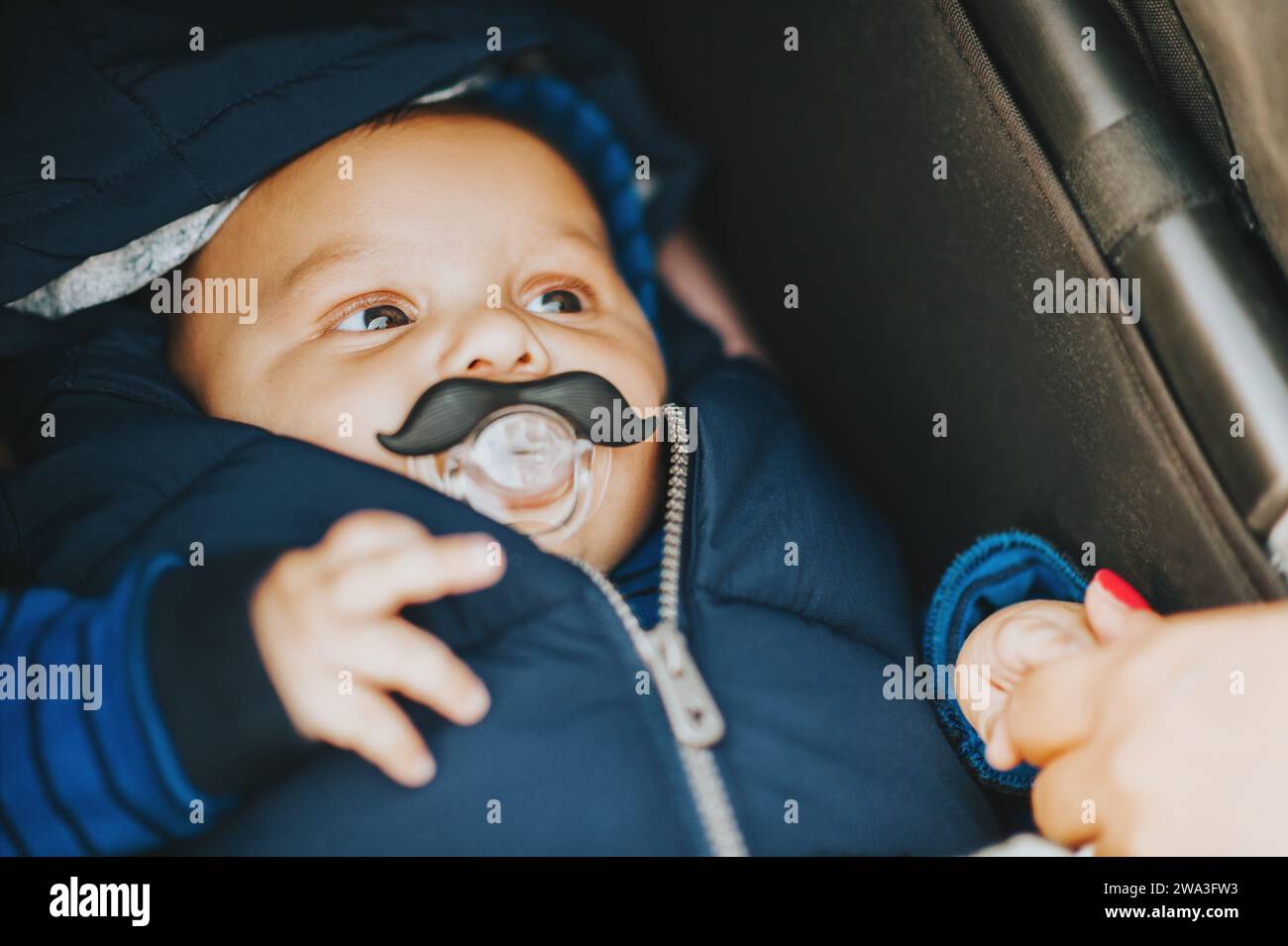 Close up portrait of adorable newborn baby boy falling asleep, lying in ...