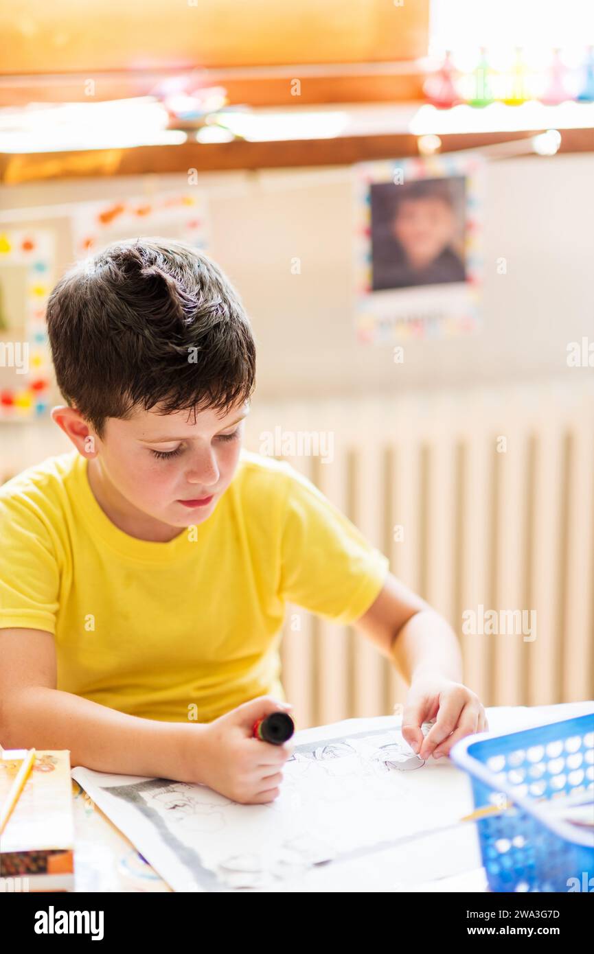 Cute little boy working in classroom, education, back to school concept ...