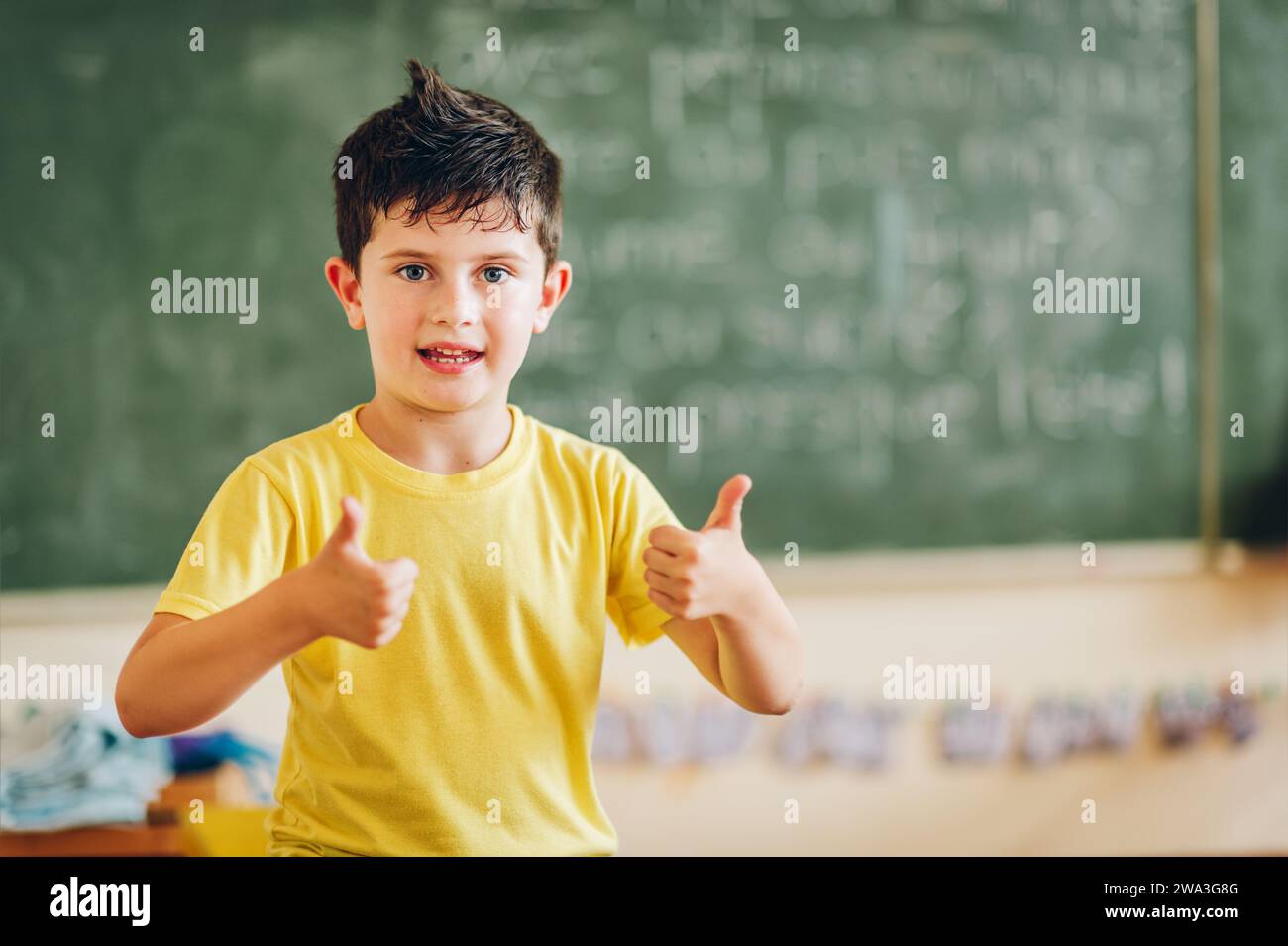 Happy child working in classroom, big thumbs up, education, back to ...
