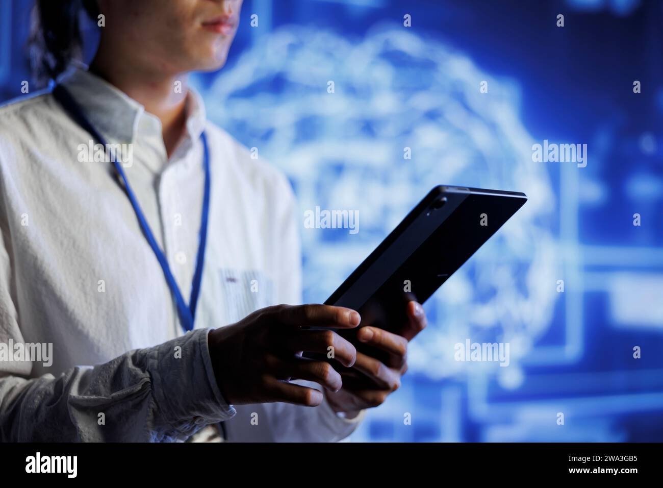 Admin using tablet in server room to maintenance artificial intelligence neural networks ...