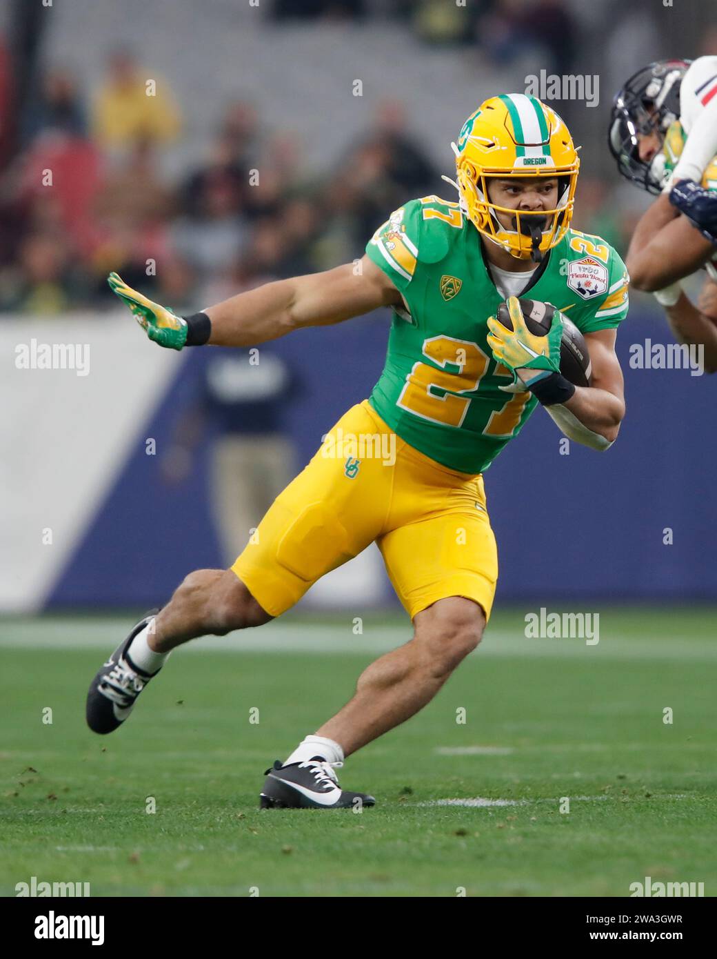 Glendale, Arizona, USA. 1st Jan, 2024. Jayden Limar (27) of the Oregon Ducks carries the ball ...