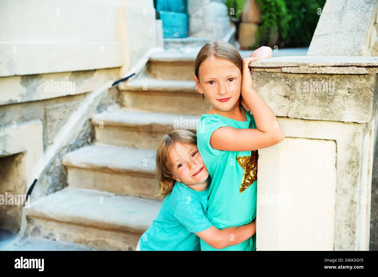 Two adorable kids playing outdoors together Stock Photo - Alamy