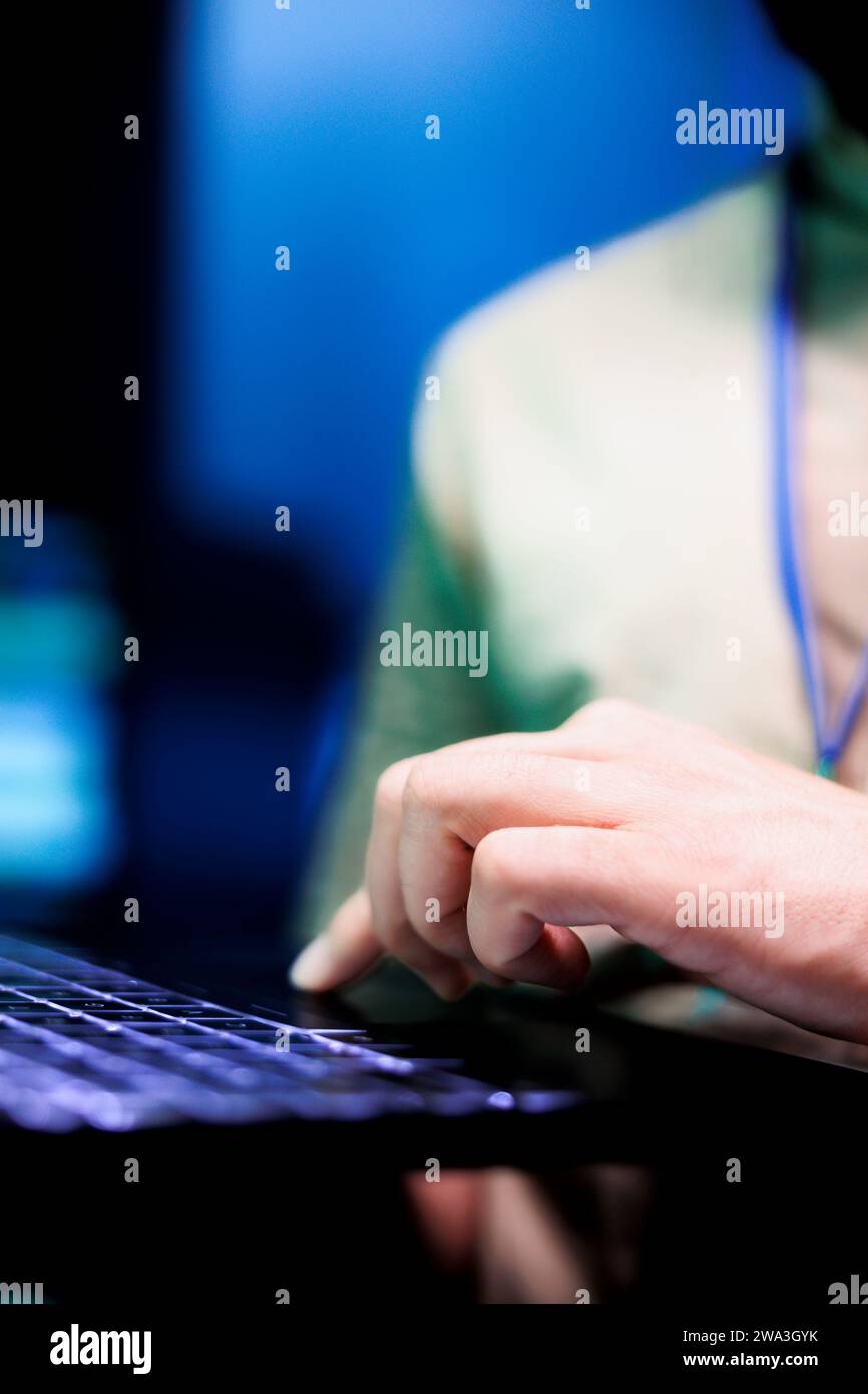 Close up of engineer in data center using laptop to work with essential ...