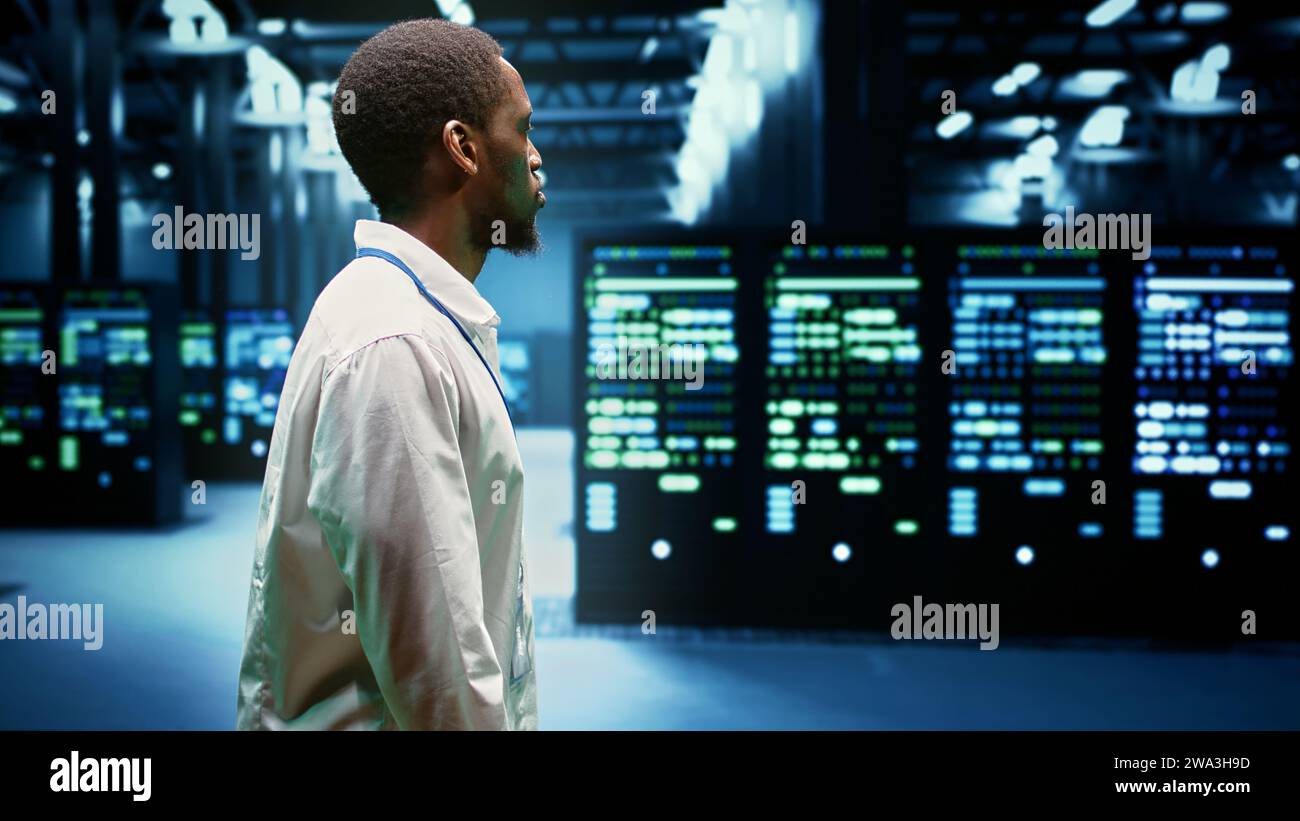 Electrician Walking In High Tech Server Facility Performing Data Backups And Providing