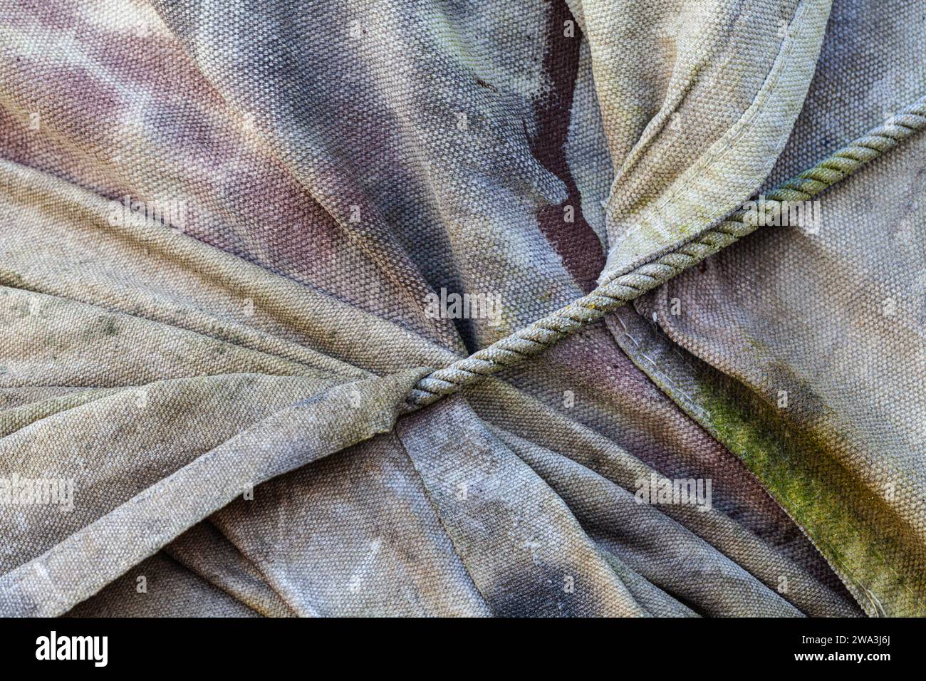 Abstract image of a weathered canvas sheet covering some stored ...