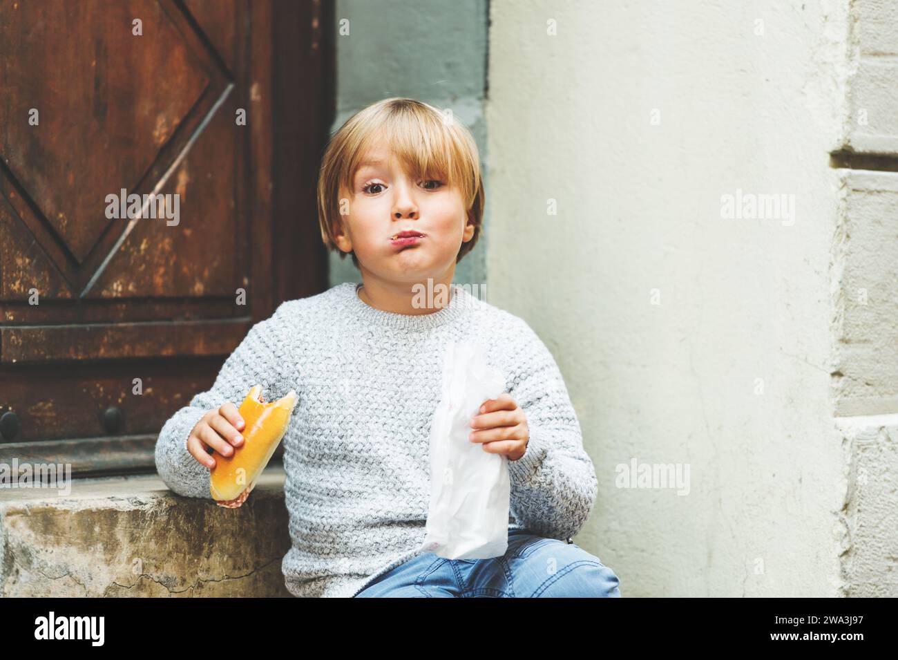 Adorable kid boy eating salami sandwich outside Stock Photo - Alamy
