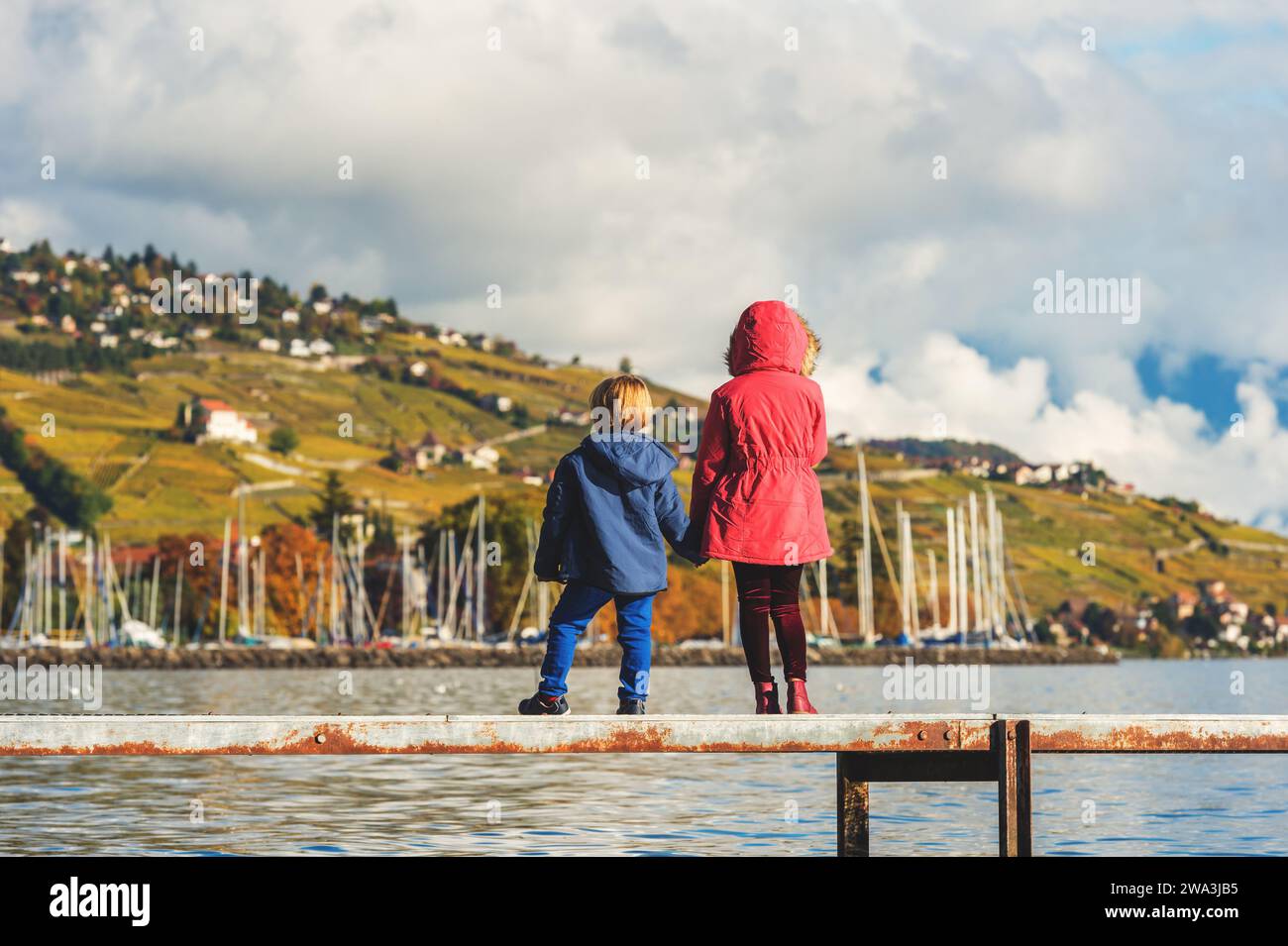 Two kids admiring amazing view of Lake Geneva, Switzerland, back view ...