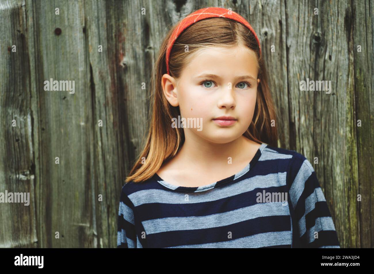 Outdoor portrait of cute little 8-9 year old girl with brown hair ...