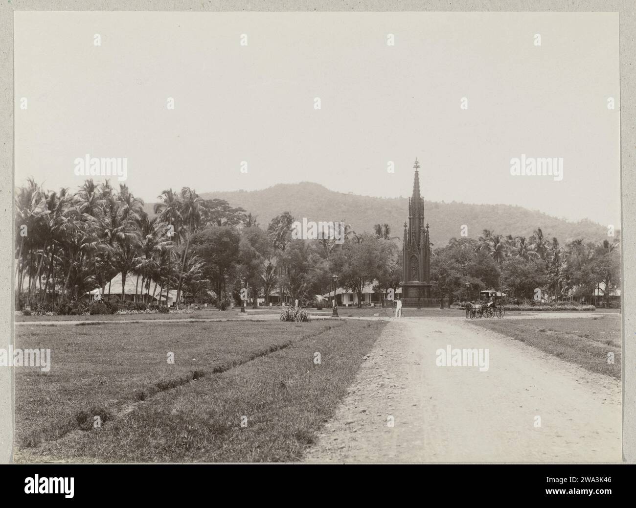 Monument on a square in the Dutch East Indies with a carriage and a ...