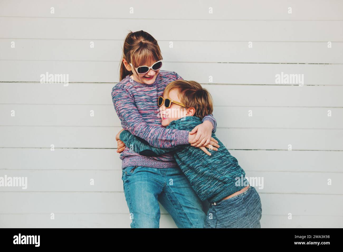 Group of two funny kids playing together outside, little boy and girl ...