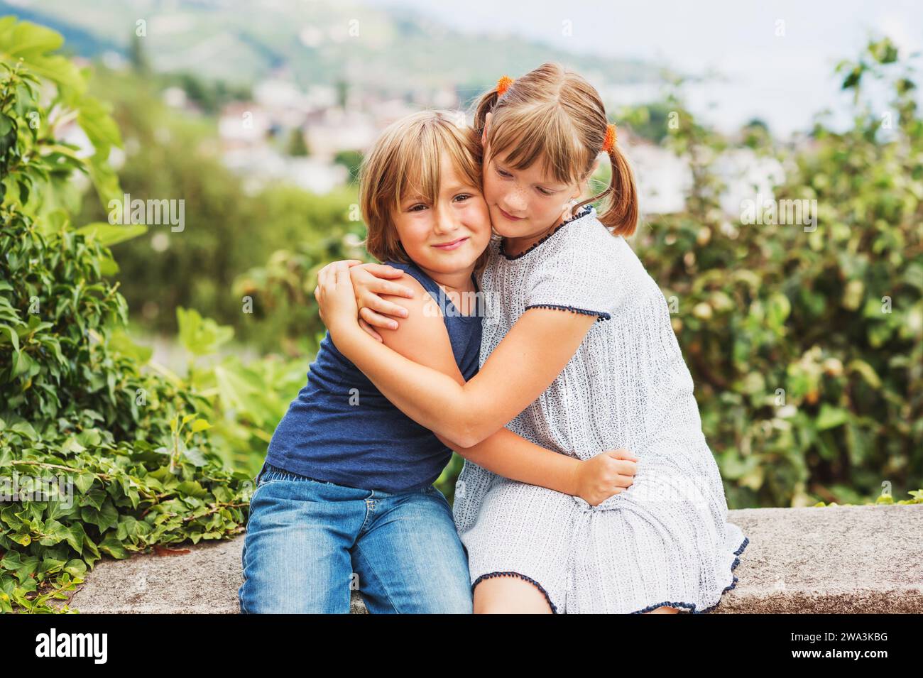 Happy little kids hugging each other, brother and sister playing together, siblings love Stock ...