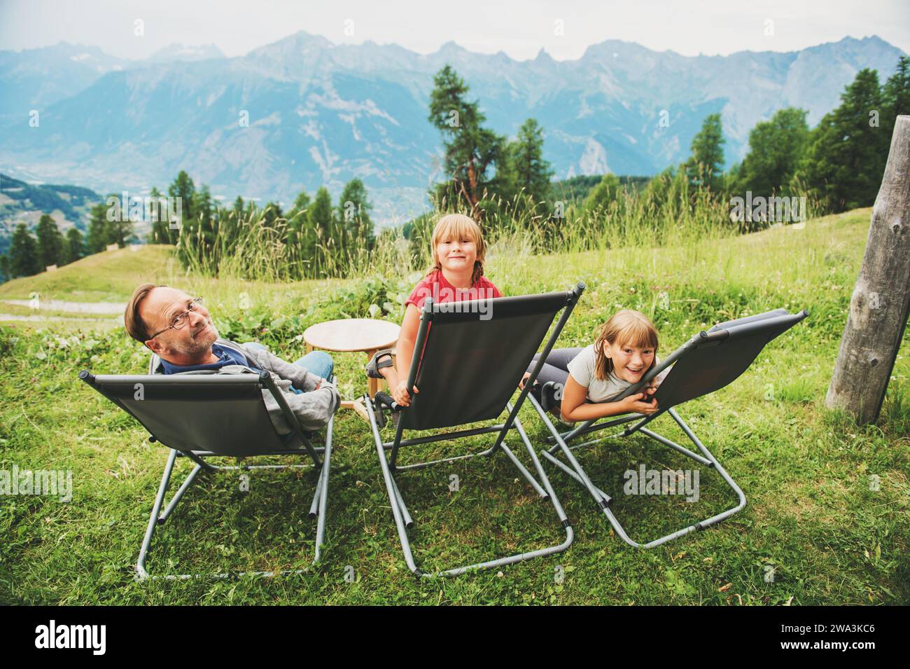 Happy family hiking in swiss Alps, enjoying amazing view, travel with ...