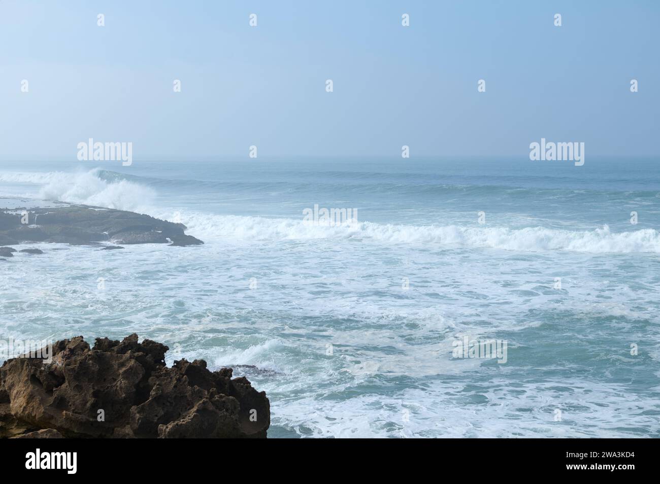 Beautiful view of Atlantic ocean on foggy day. Splashing waves crashing ...