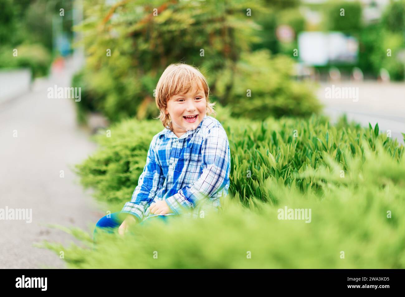 Funny little boy playing outdoors, kid having fun in green park Stock ...