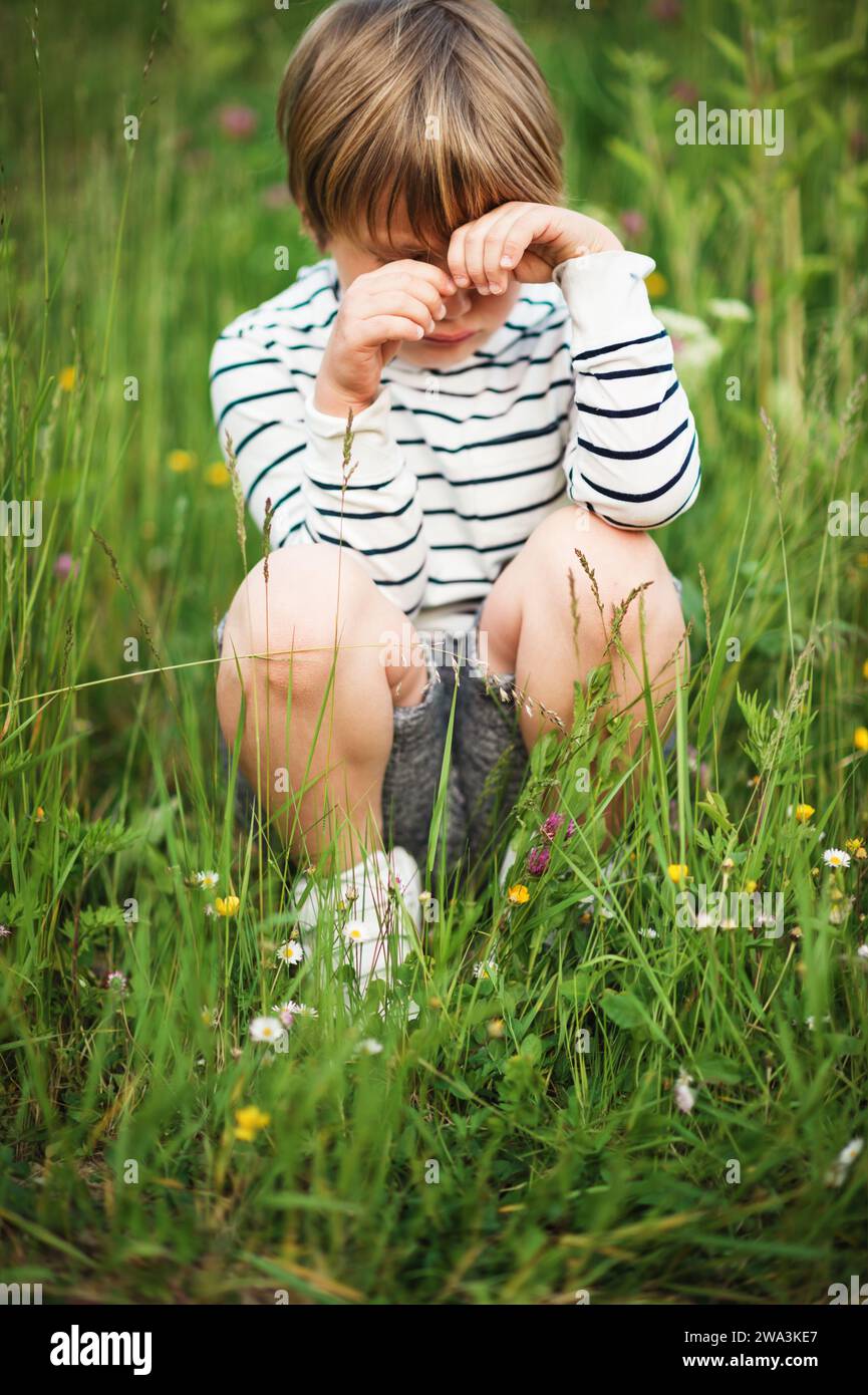 Sad 6 year old kid boy outdoor portrait Stock Photo - Alamy