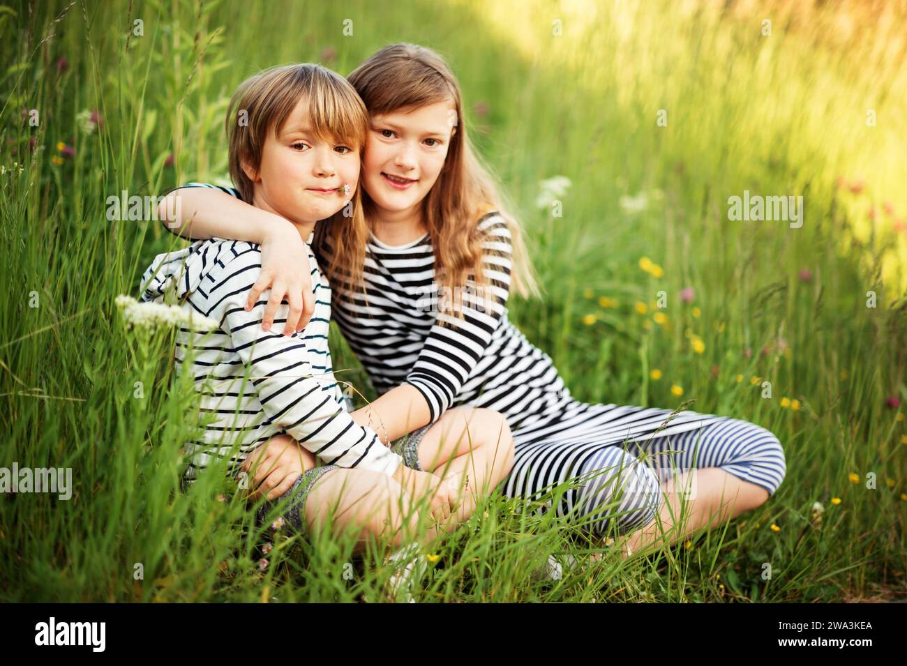 Outdoor portrait of two adorable kids playing together Stock Photo - Alamy